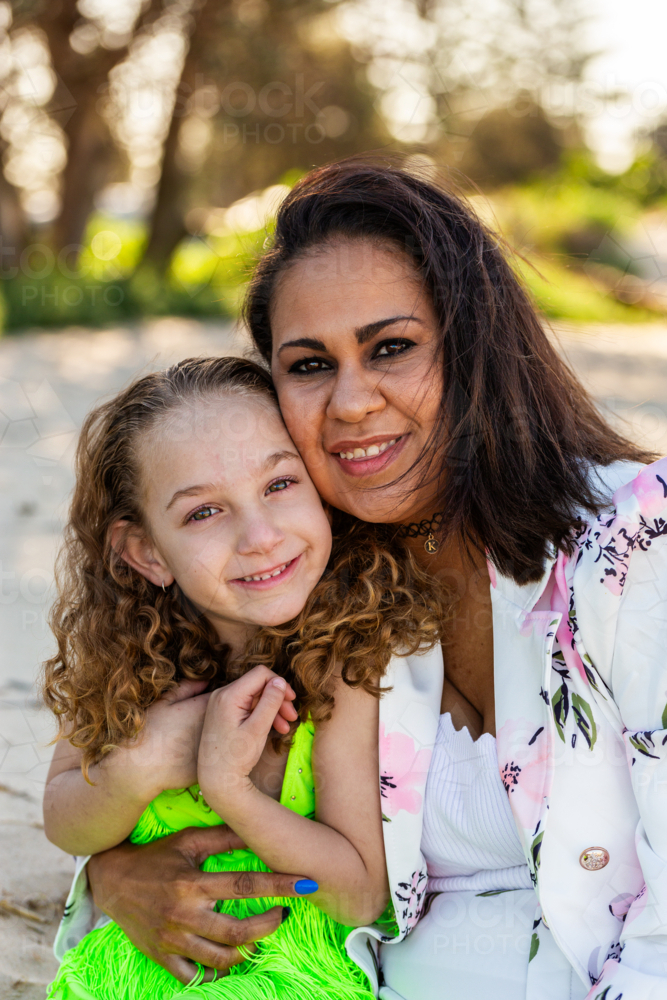 Image of Portrait of Torres Strait Islander mother in her thirties and young daughter together ...
