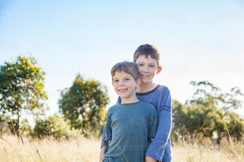 Image of Portrait of two happy Aussie kids with copy space standing in ...