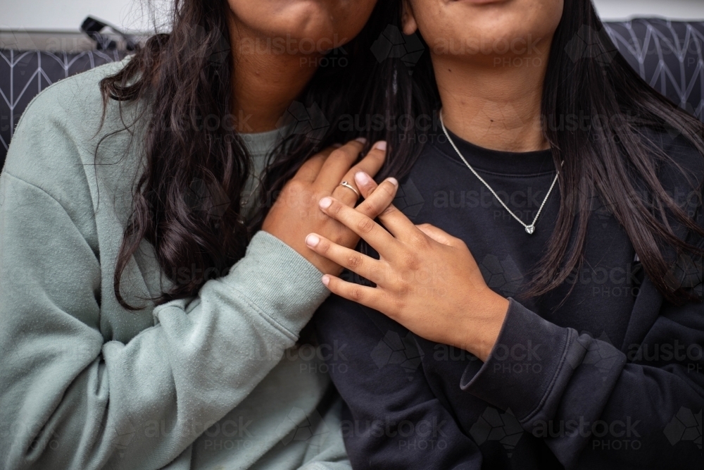 Image of portrait of two young girls leaning on each other - Austockphoto