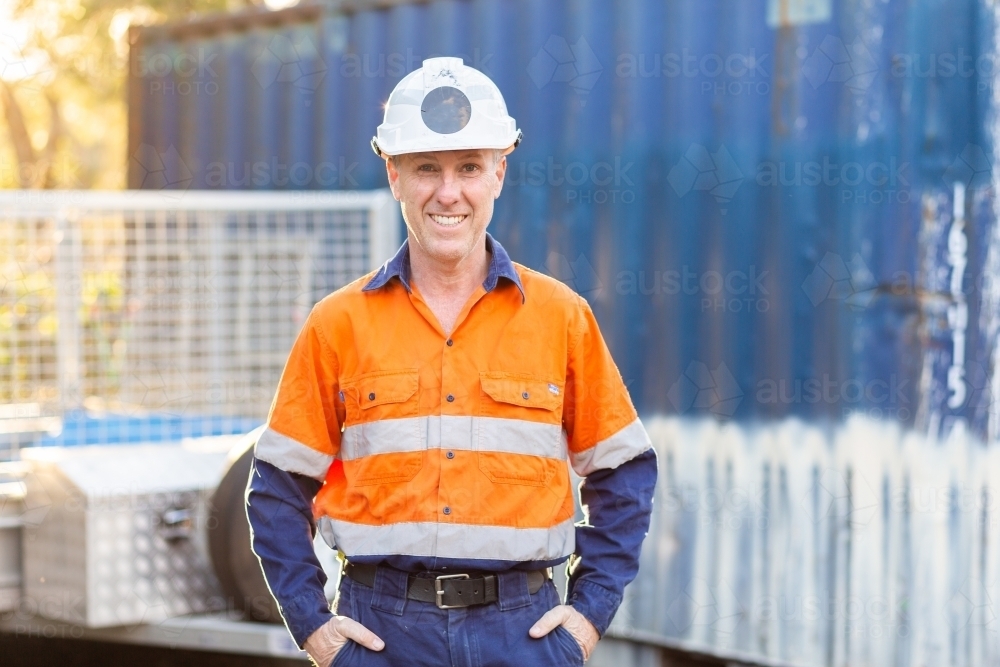 Image of Portrait of worker infront of shipping container with hard hat ...