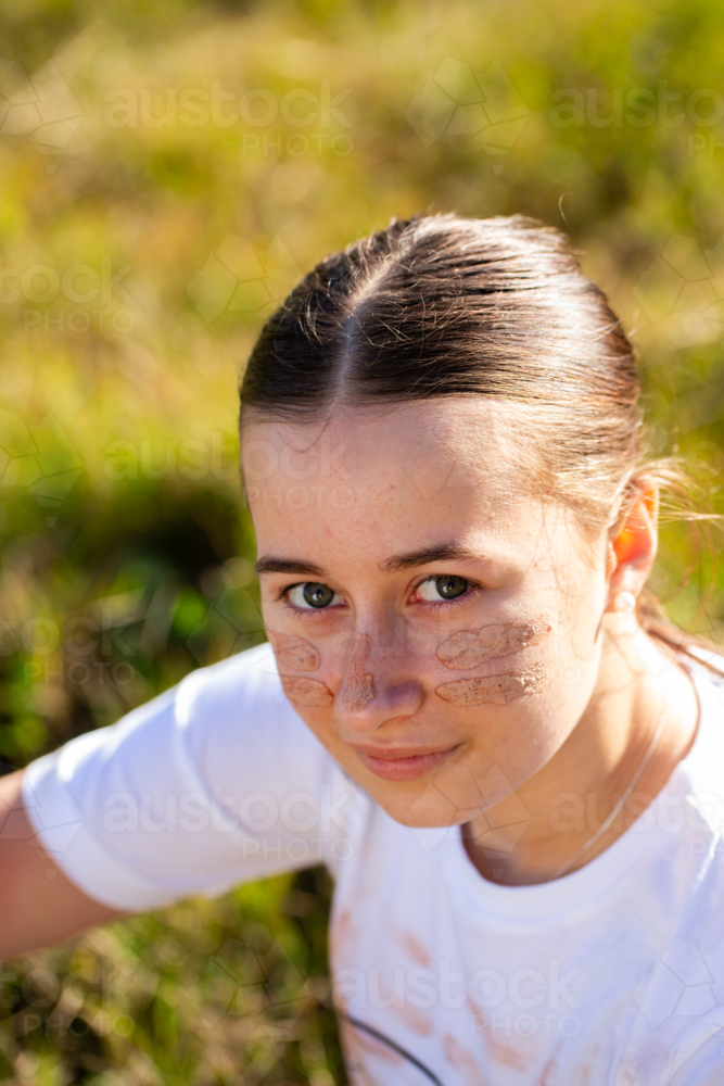 Image of Portrait of young aboriginal person sitting in grass ...