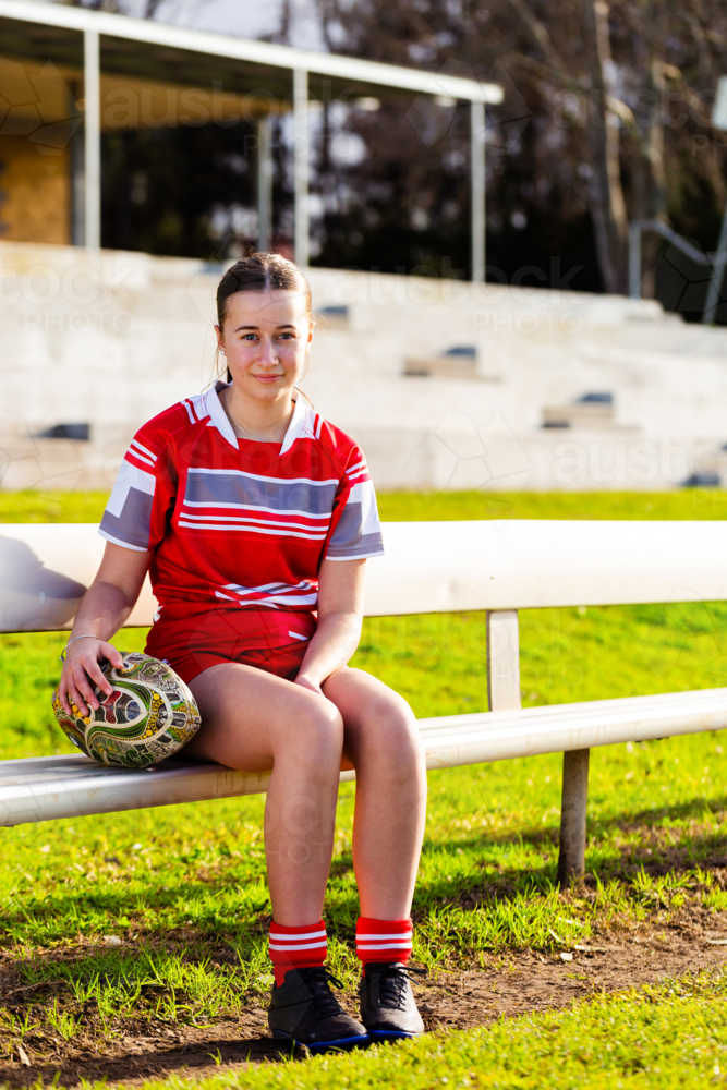 Image of Portrait of young aboriginal teen footy player with football ...