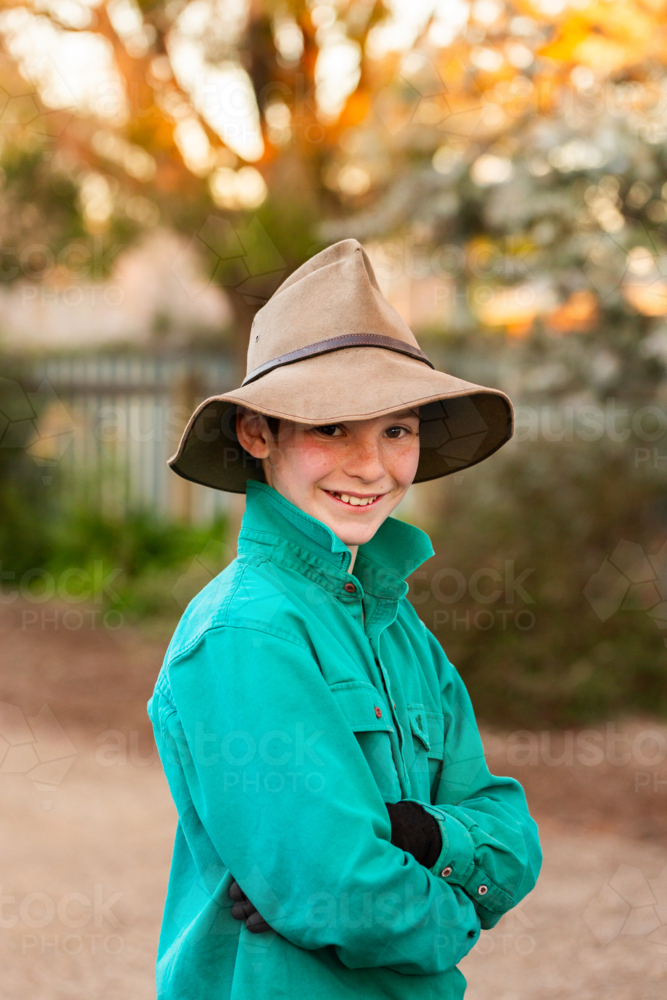 Image of Portrait of young Australian boy in backyard with akubra hat ...