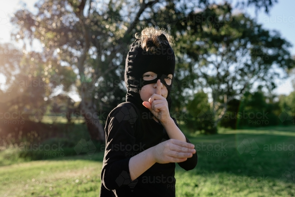 Image of Portrait of young boy dressed up in Ninja costume, wearing a ...