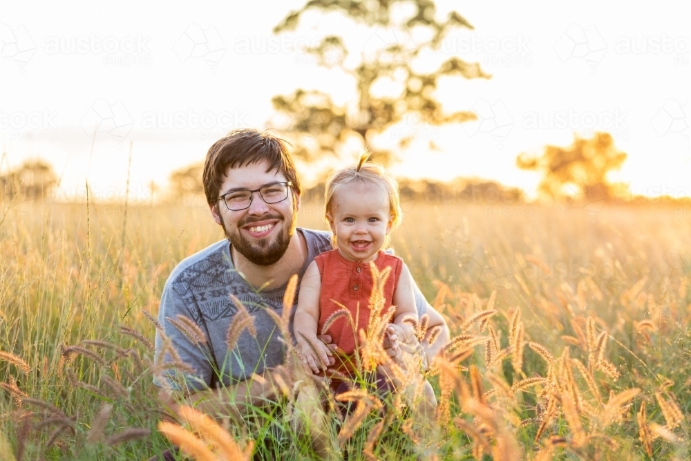 Image of Portrait of young father in his early twenties with baby girl ...