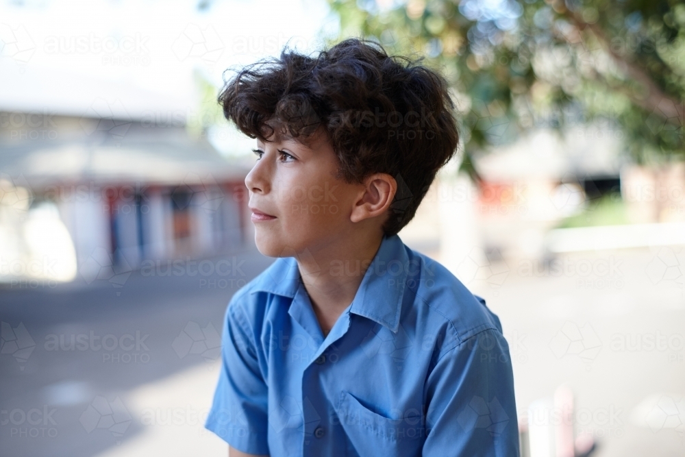 Image of Portrait of young school boy thinking - Austockphoto