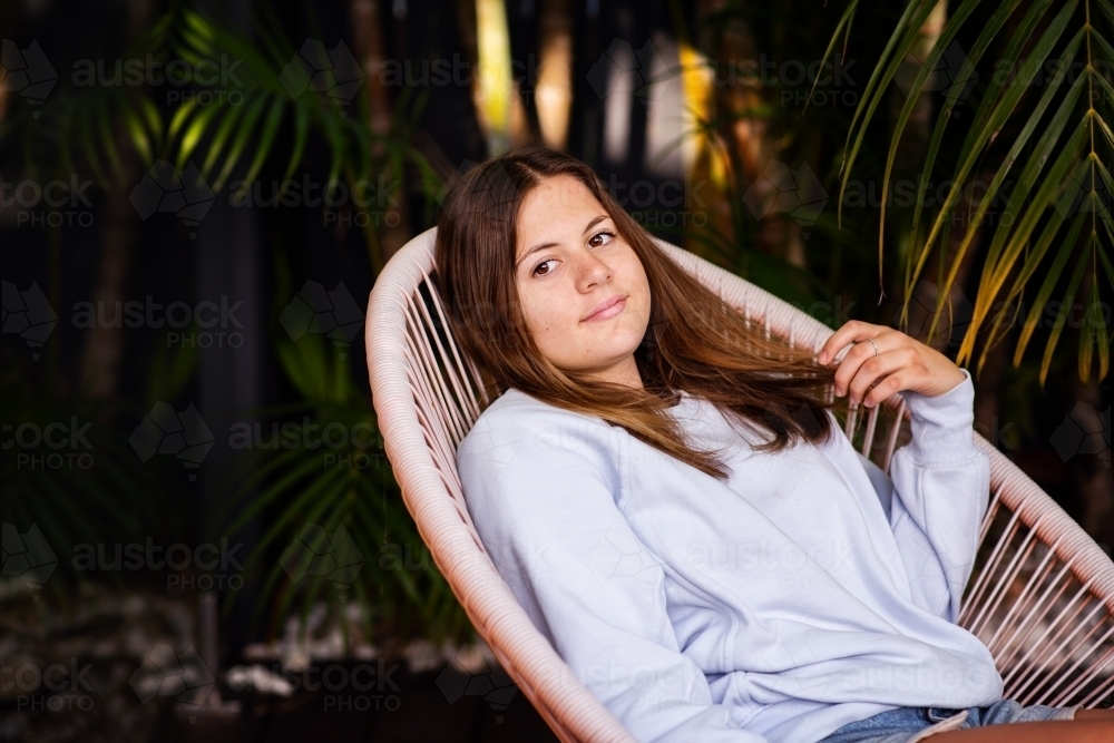 Image of portrait of young teen girl, sitting in chair outside ...