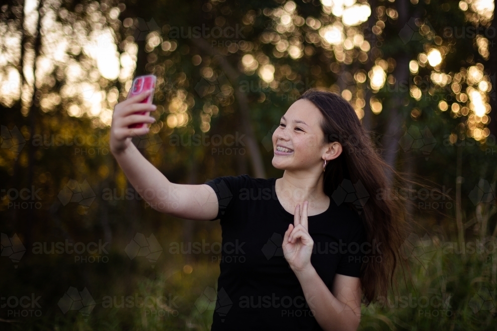 Image of pose with phone - Austockphoto