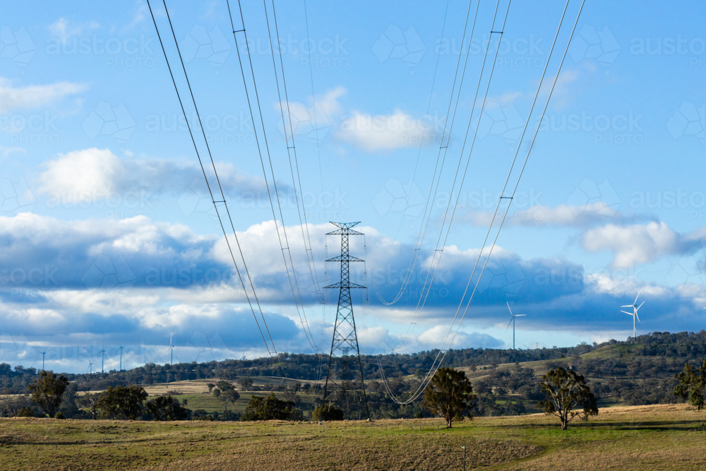 Image of Powerlines and wires of the energy grid with wind turbines on ...