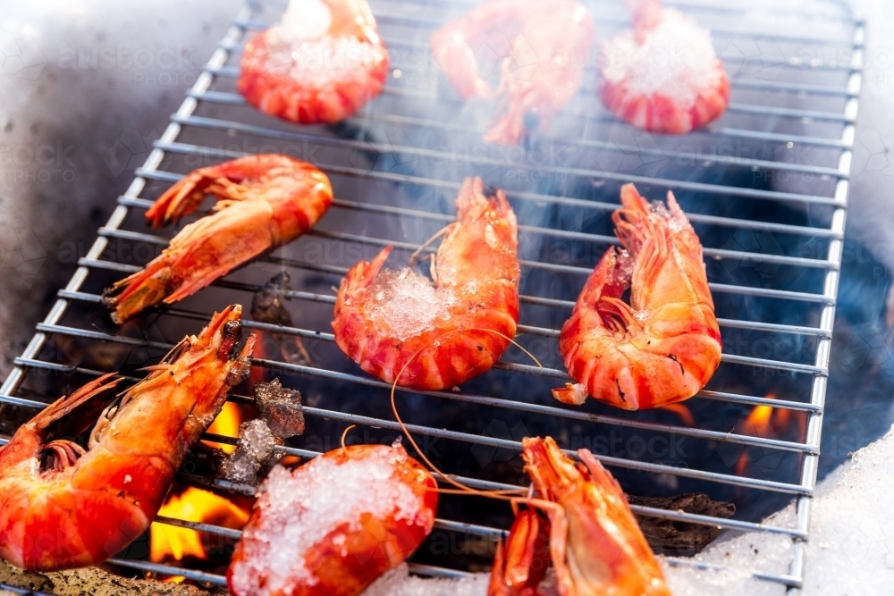 Image of Prawns being cooked over pit in the snow - Austockphoto