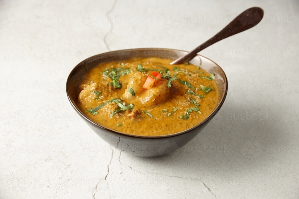 Image of Prawns malabari curry dish on table - Austockphoto