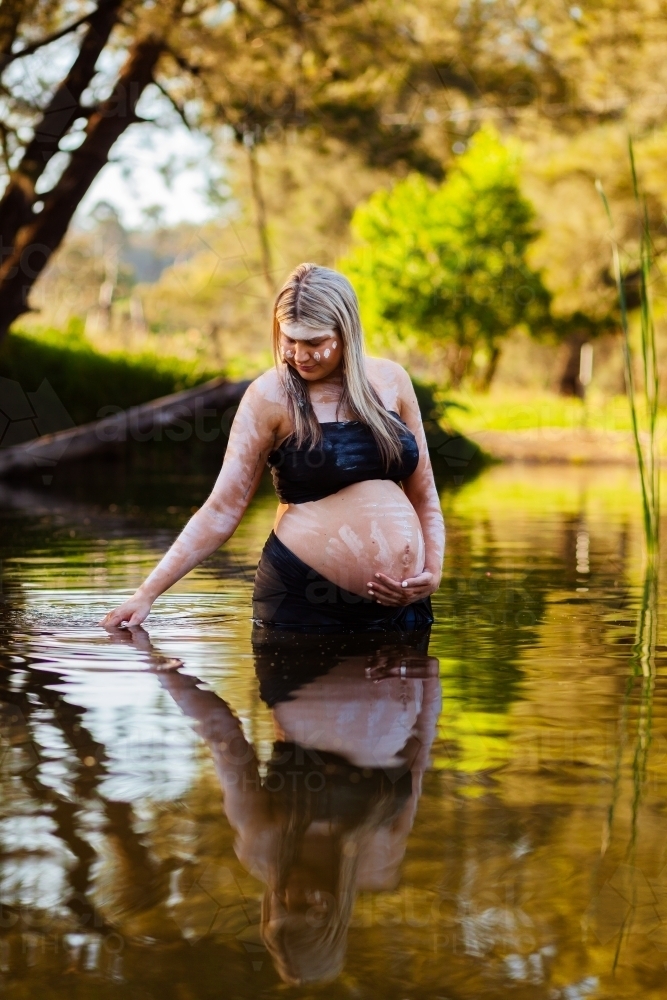 Image Of Pregnant Aboriginal Australian Woman In Traditional Ochre Body