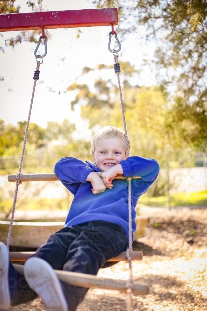 Image of Preschool age child posing on rope ladder swing for ...