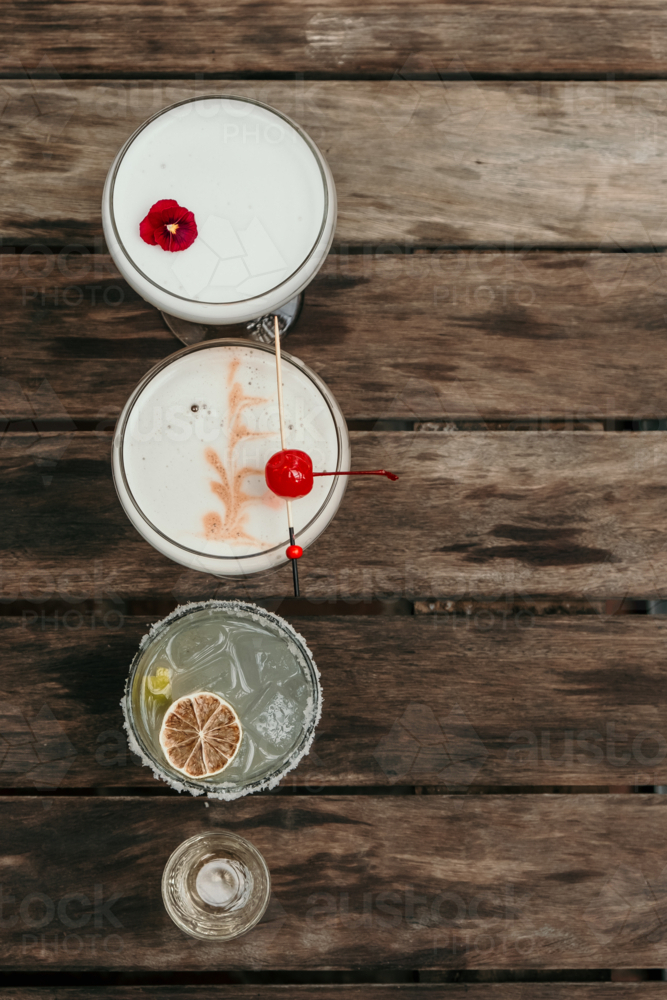 Image of Pretty cocktails in a row from above. - Austockphoto