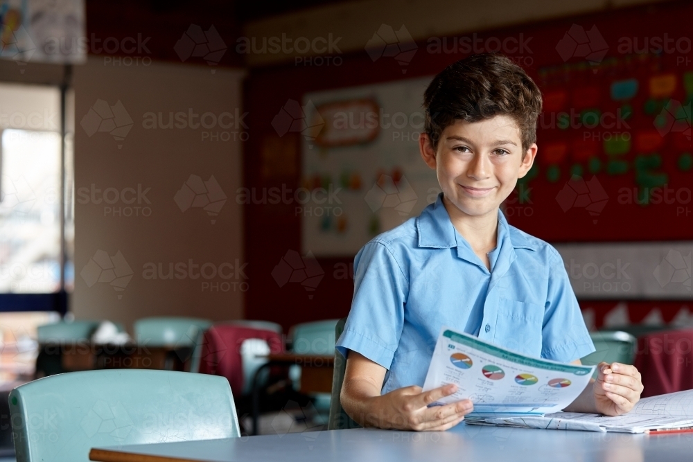 Image of Primary school student in classroom working on homework ...
