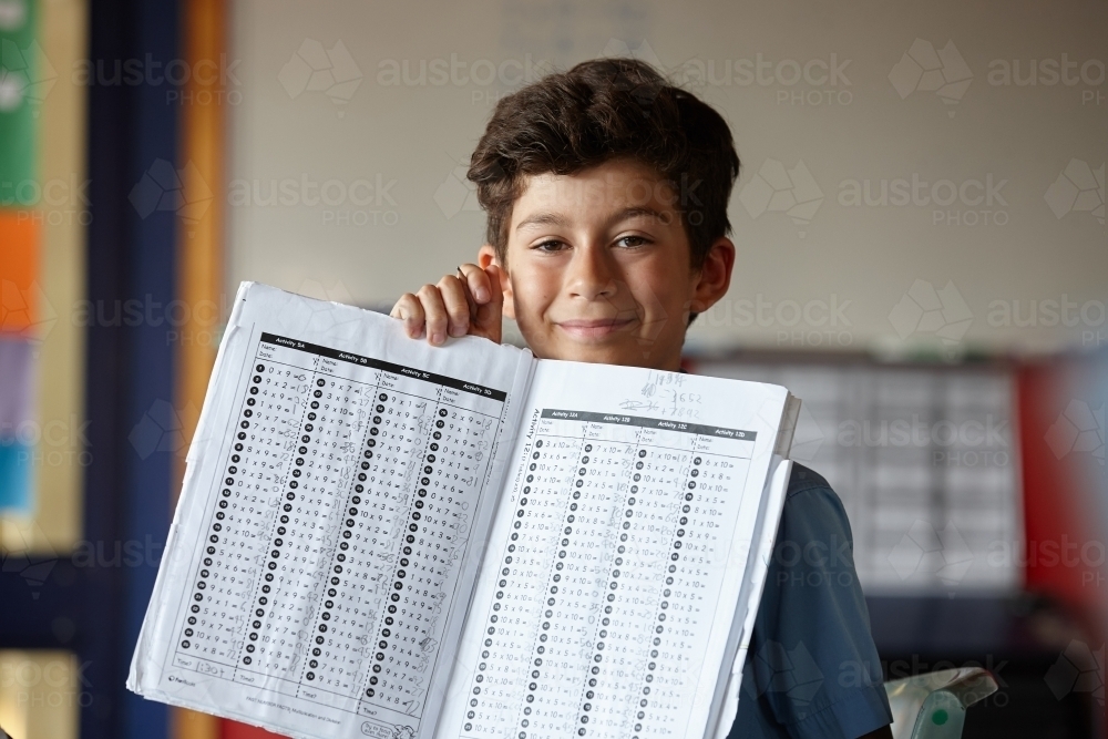 Image of Primary school student in classroom working on homework ...