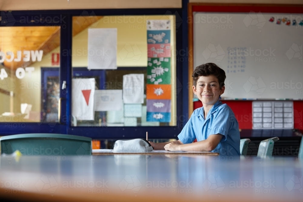 Image of Primary school student in classroom working on homework ...