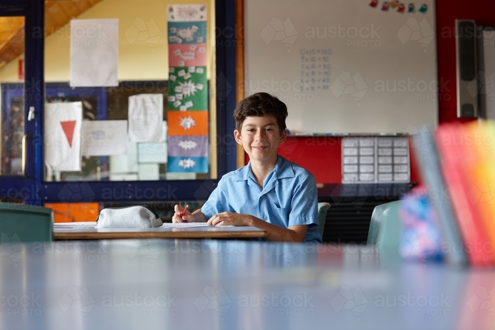 Image of Primary school student in classroom working on homework ...