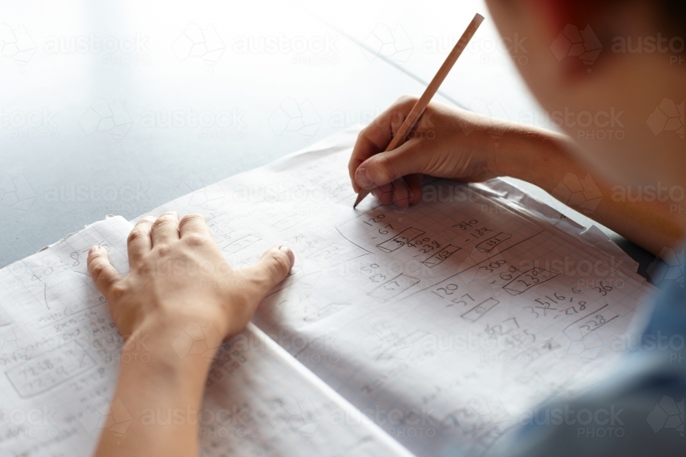 Image of Primary school student in classroom working on homework ...