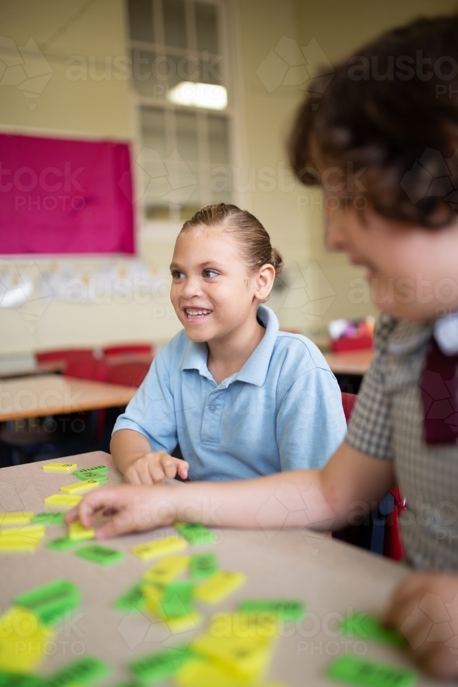 Image of Primary school students sitting and working with coloured word ...