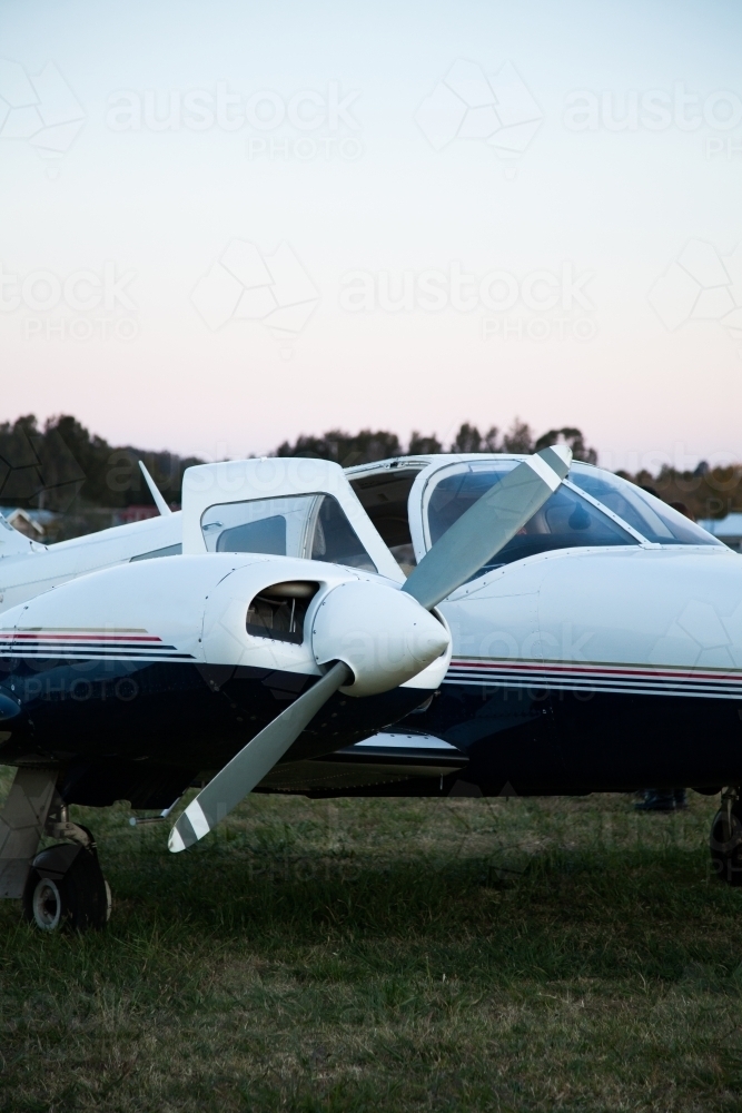 Image of Private twin engine aeroplane on rural landing strip at dusk ...