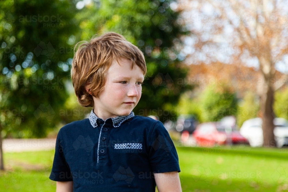 Image of profile of unsure young autistic boy looking to the side at a ...