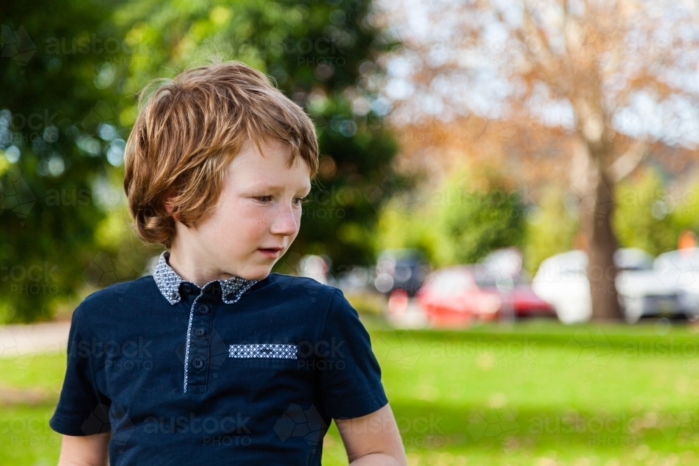 Image of profile of unsure young autistic boy looking to the side at a ...