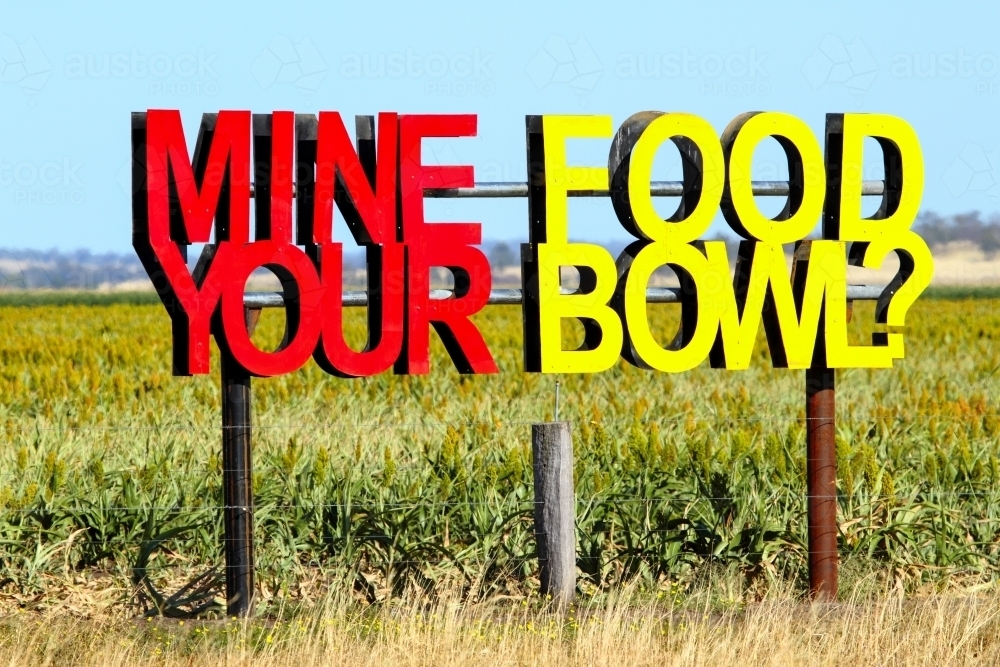 Image of Protest sign in farm paddock - Mine your food bowl? - Austockphoto