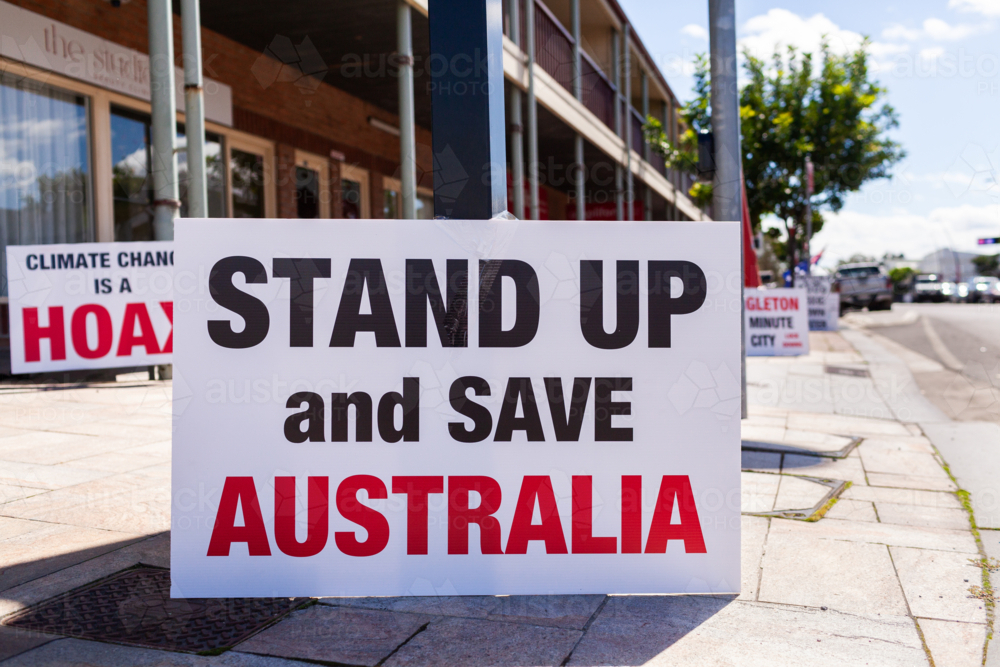 Image of Protest sign set up on pavement along street of country town ...