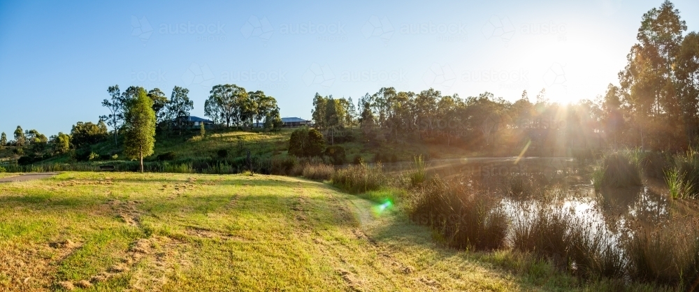 Image of public park with sun rising over dam in Singleton Heights ...
