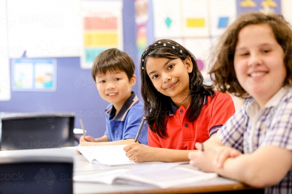 Image of Public school students sitting at their desk smiling ...