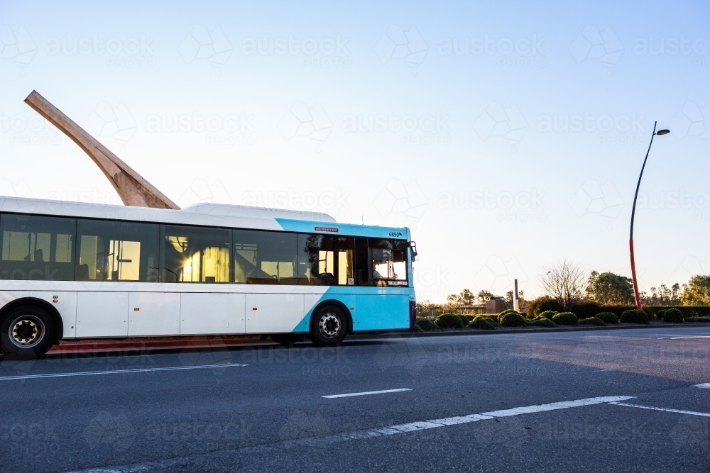 Image of Public transport bus driving along road with copy space in ...