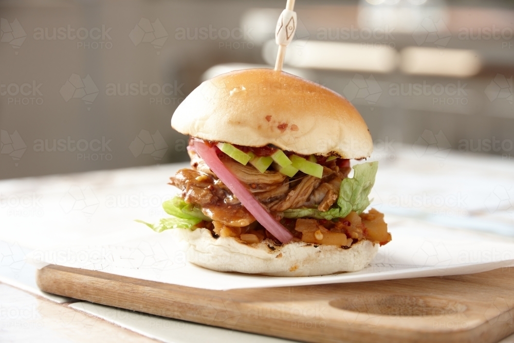 Image of Pulled beef burger on board - Austockphoto