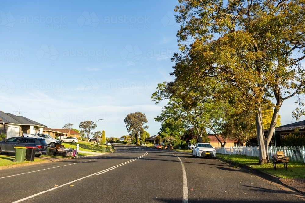Image of quiet street in town with piles of rubbish during curb side ...