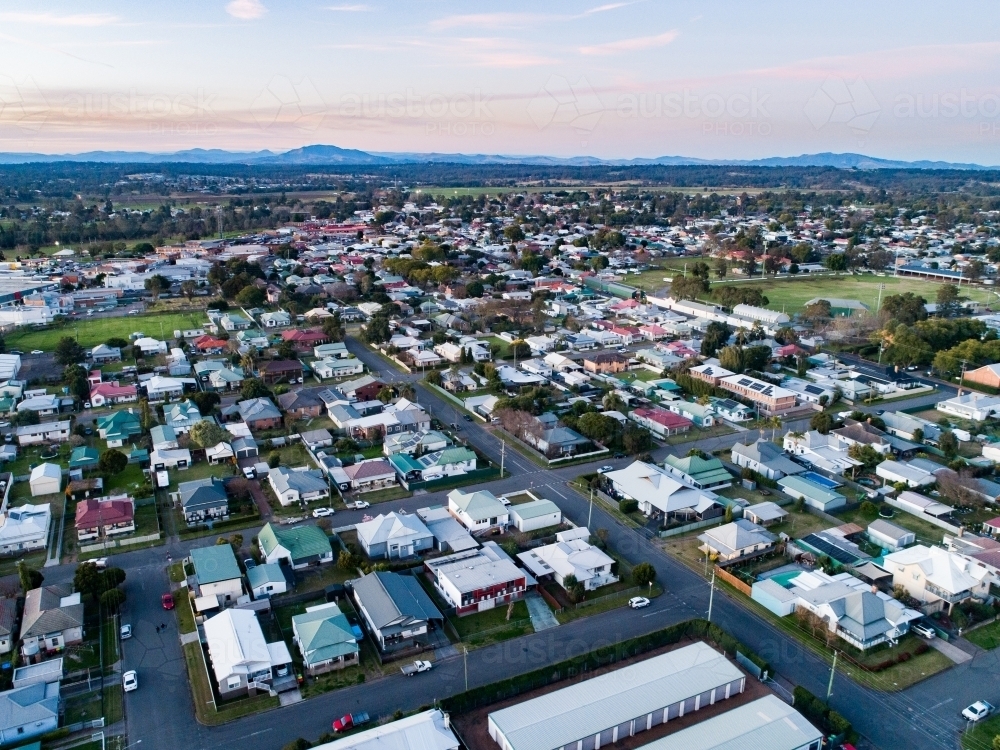 Image of Quiet streets and homes at dusk in country town - Austockphoto
