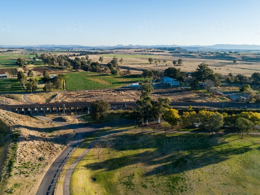 Image of railway bridge beside parkland and farm paddocks before the ...
