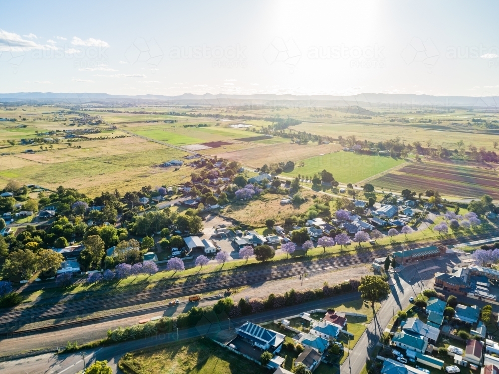 Image of Railway line train track and singleton station lined with ...