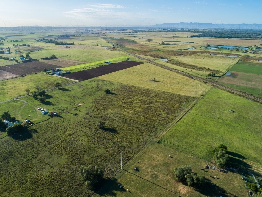 Image of Railway train line seen from aerial view cutting through rural ...