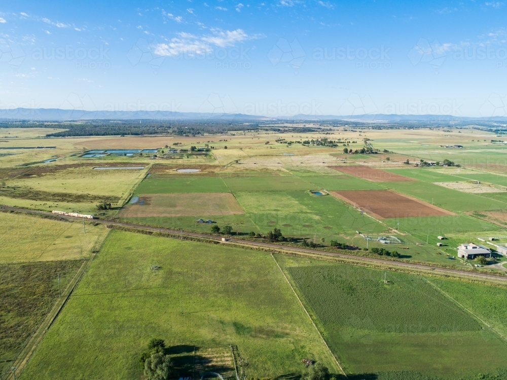 Image of Railway train line seen from aerial view cutting through rural ...