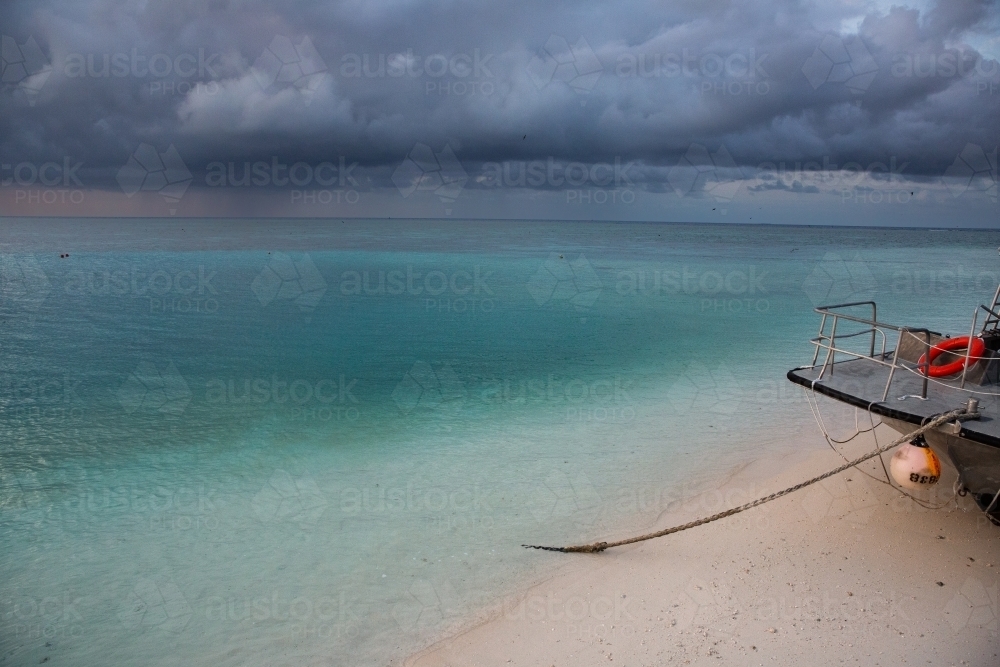 Image of rain coming in towards Heron Island with a dive boat tied up ...