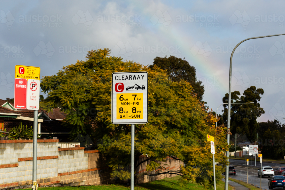 Image of Rainbow behind clearway sign on Sydney roadside - Austockphoto