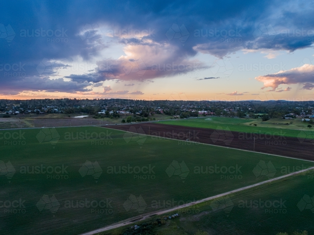Image of Rainfall on the horizon over farm paddocks in rural town ...