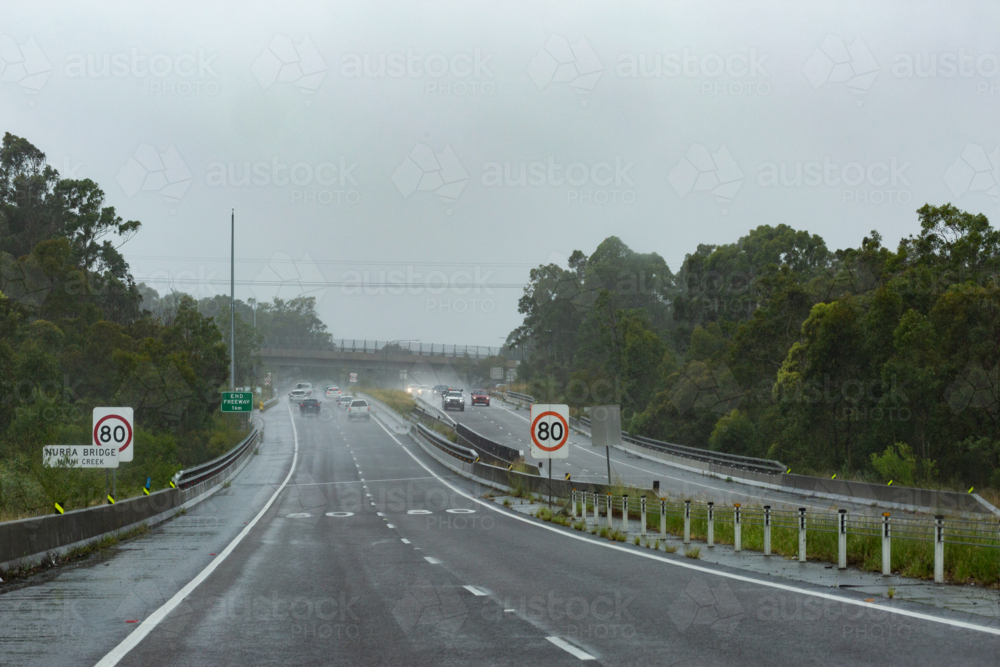 Image of Rainy stormy day with cars driving on wet highway road with 80 ...