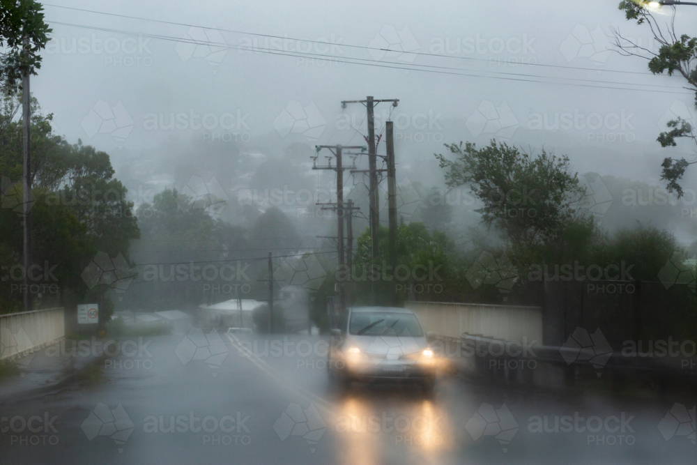 Image of Rainy stormy day with vehicles driving on slippery wet road ...