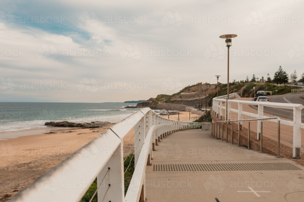 Image of Ramp leading down to Newcastle Beach beside road - Austockphoto