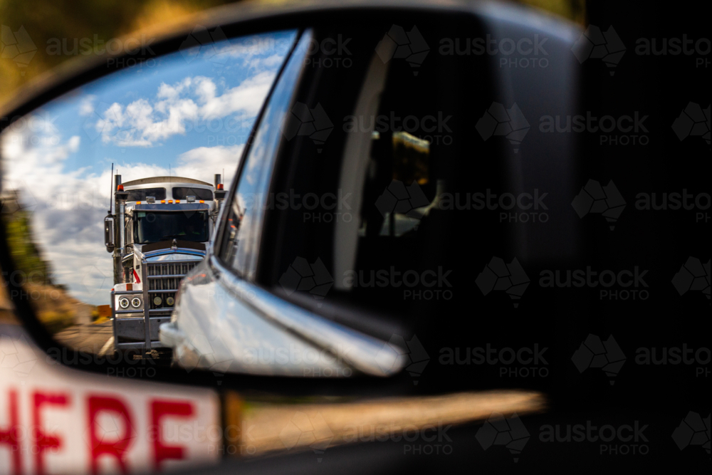 Image of Rear view mirror view of truck pulling up behind car stopped ...