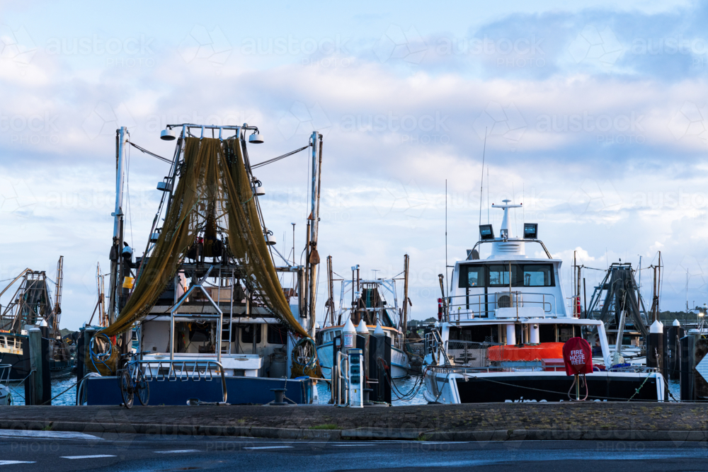 Image of Rear view of ocean going fishing boats moored in harbour ...