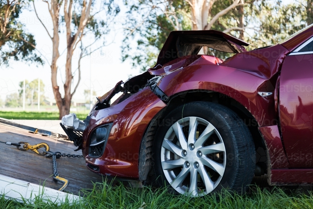 Image of Red car after a front end collision road accident being towed ...