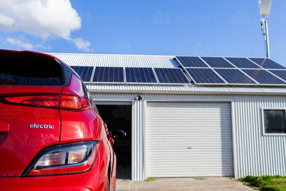 Image of Red electric vehicle with copy space and out of focus solar ...