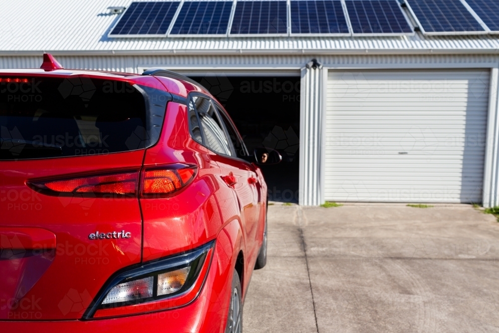 Image of Red electric vehicle with copy space and out of focus solar ...